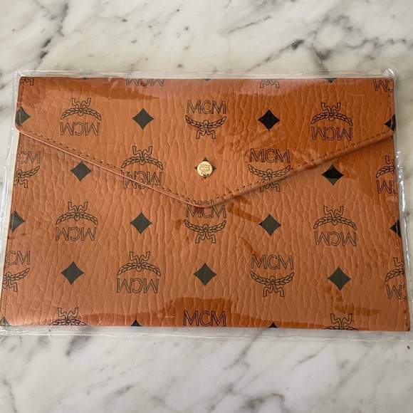 MCM | Bags | Mcm Tan Envelope Clutch With Black Logo | Poshmark